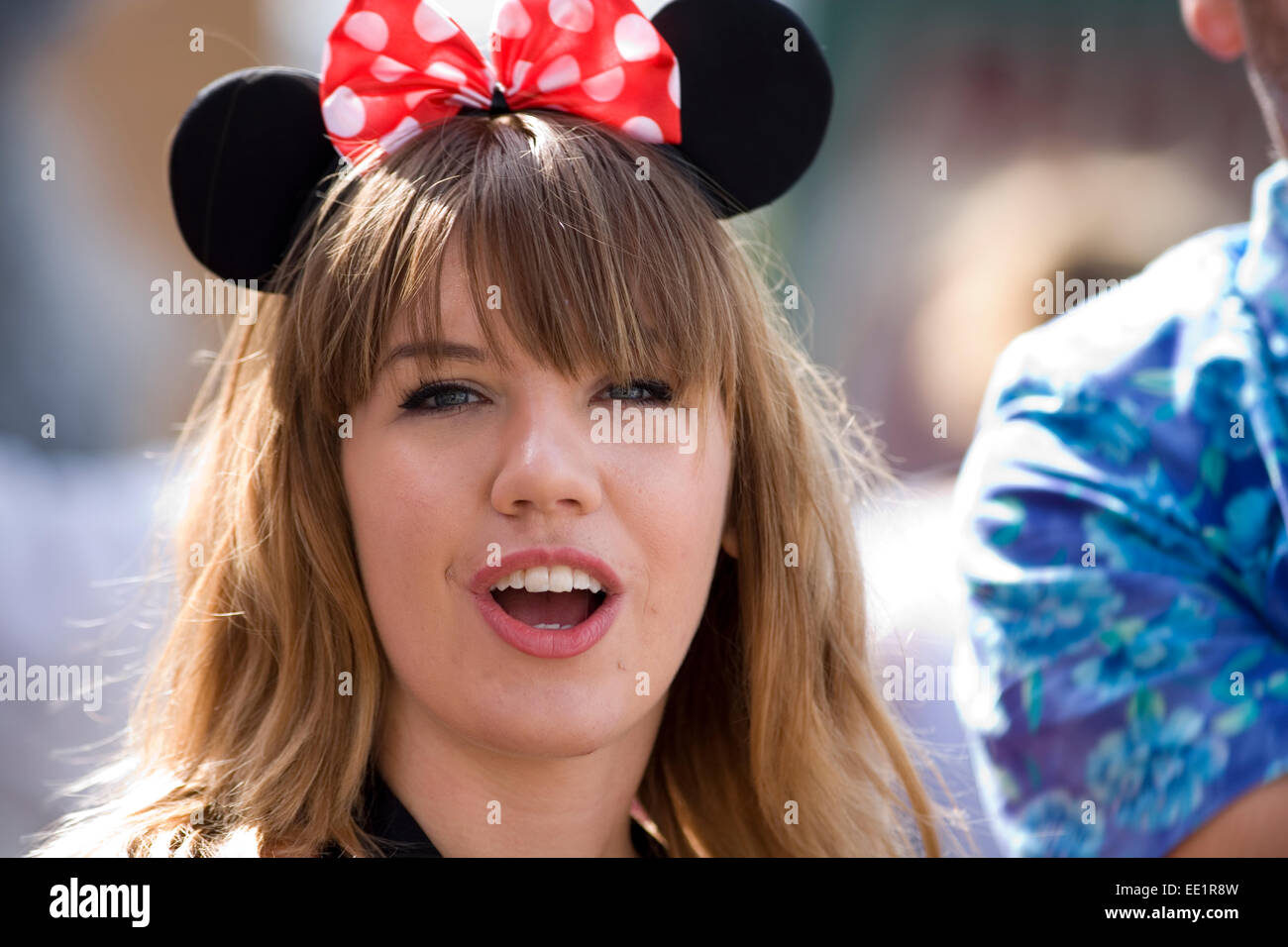A young lady with Minny Mouse ears and bow in her hair Stock Photo - Alamy
