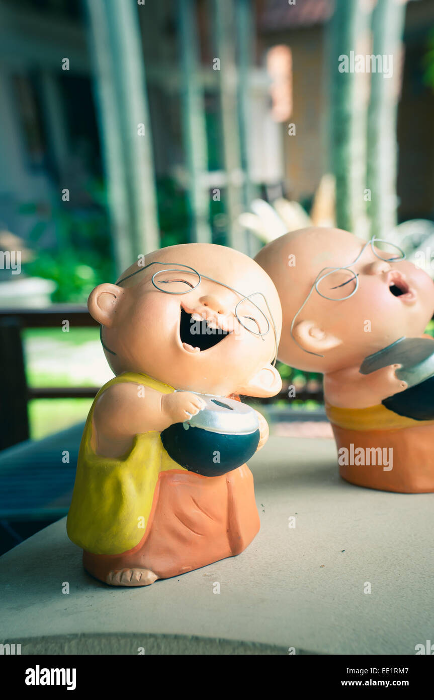 smile monk doll statue in the home Stock Photo - Alamy