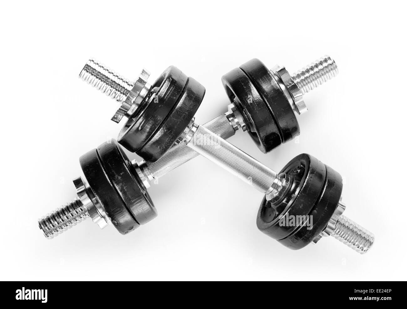 Crossed chrome hand barbells weights Stock Photo - Alamy