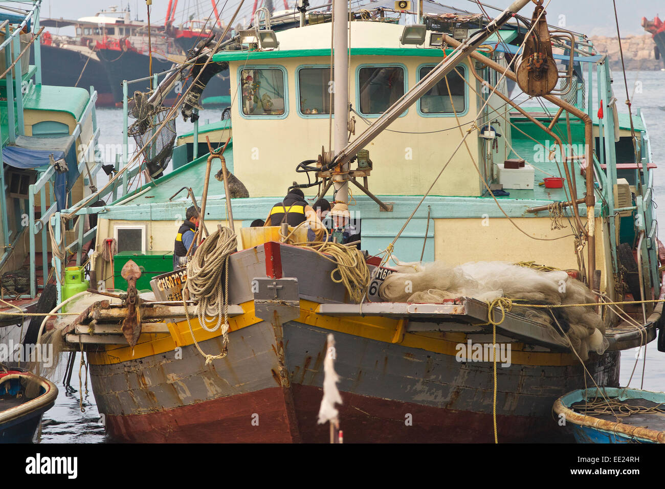 Chinese Crew Mending Nets On A Fishing Trawler On Cheung Chau Island ...