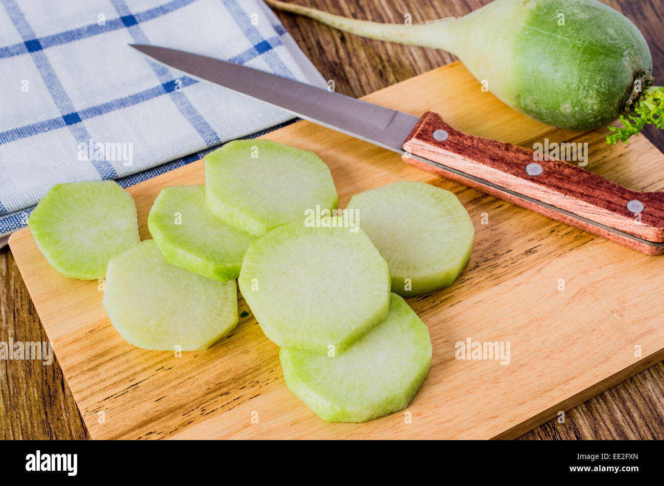 Radish slices cut with a knife on a cutting board Stock Photo - Alamy