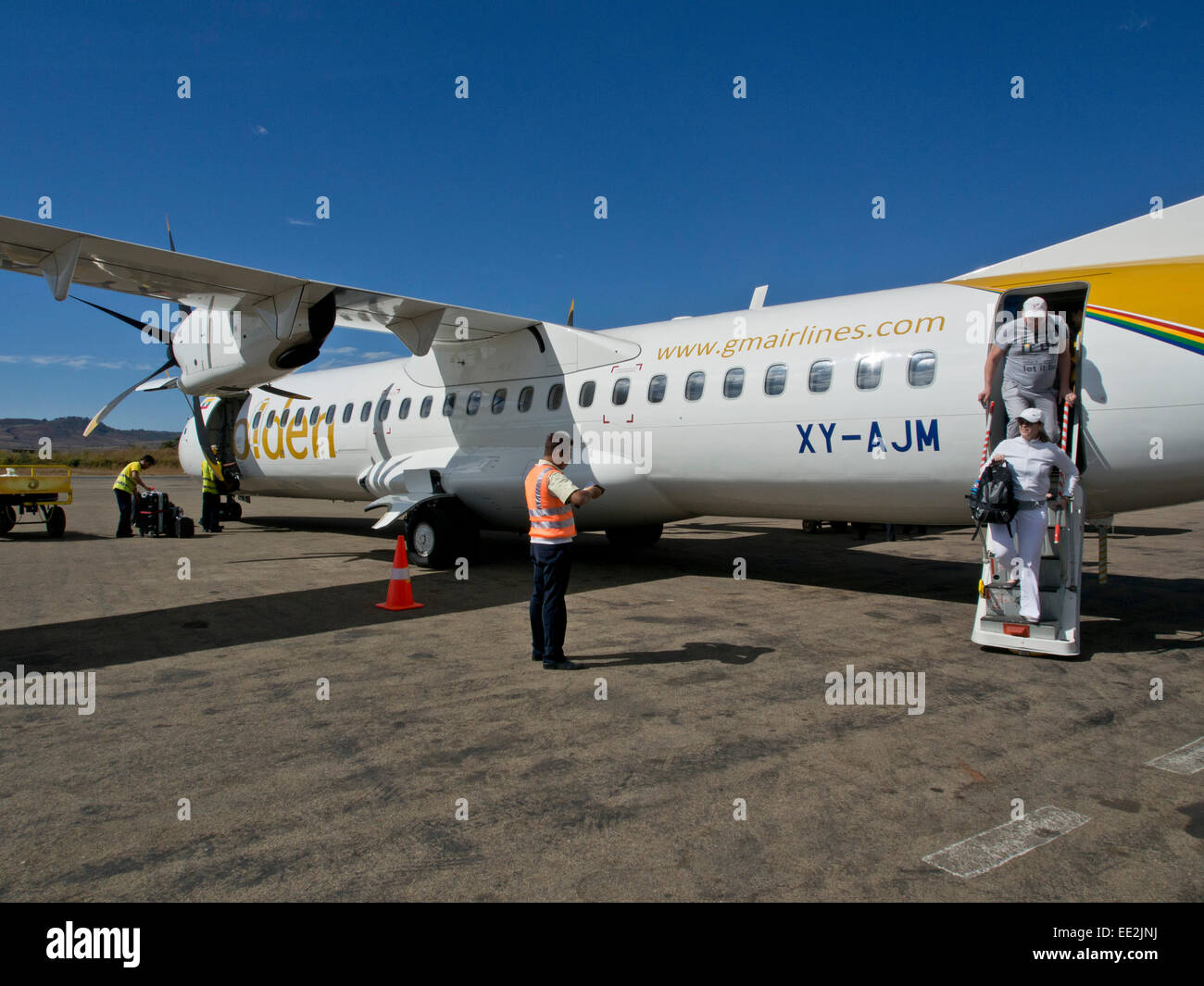 Passengers descending from Golden Myanmar plane at Bagan airport ...