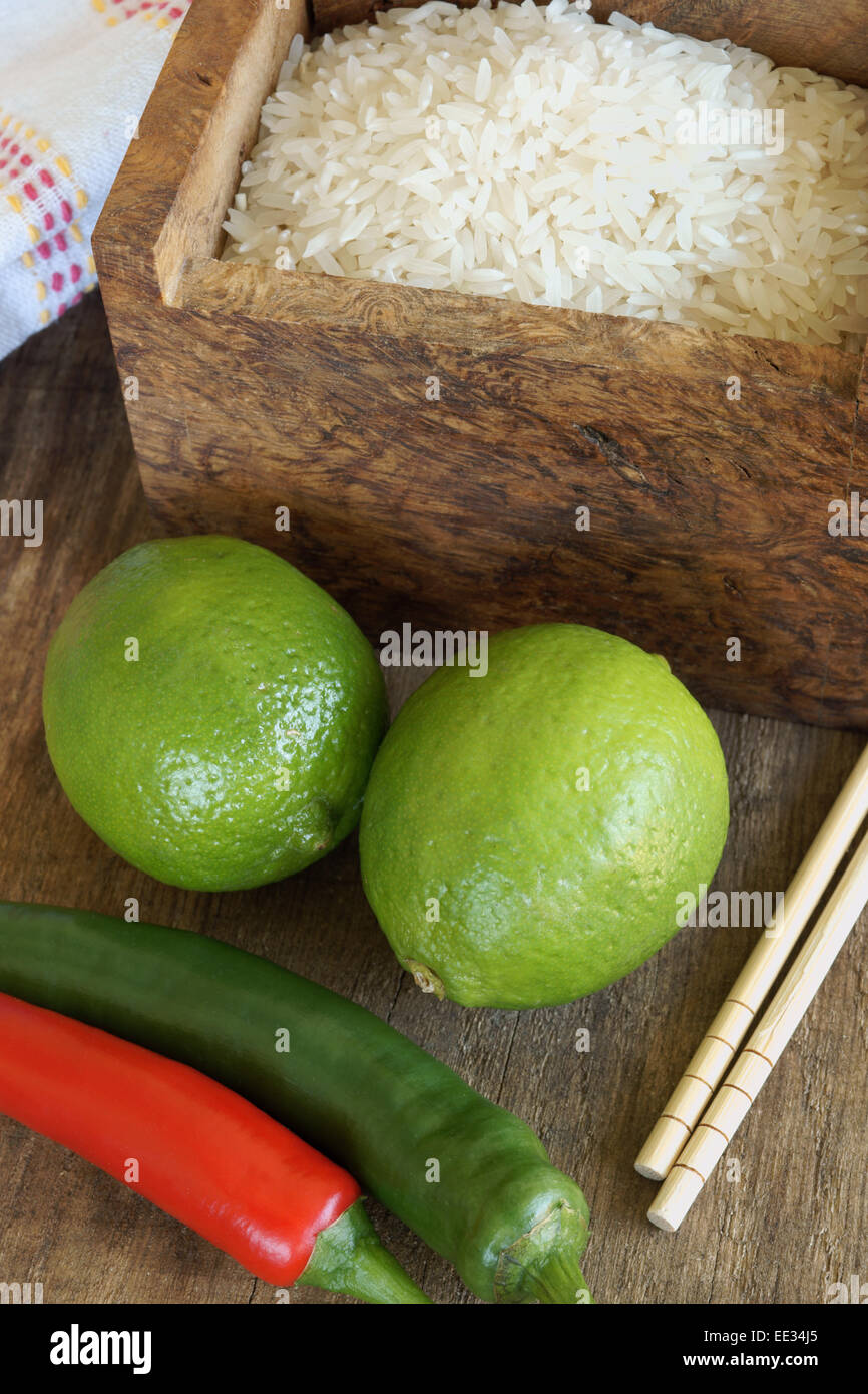 Asian food ingredients rice rice limes and chillis Stock Photo - Alamy