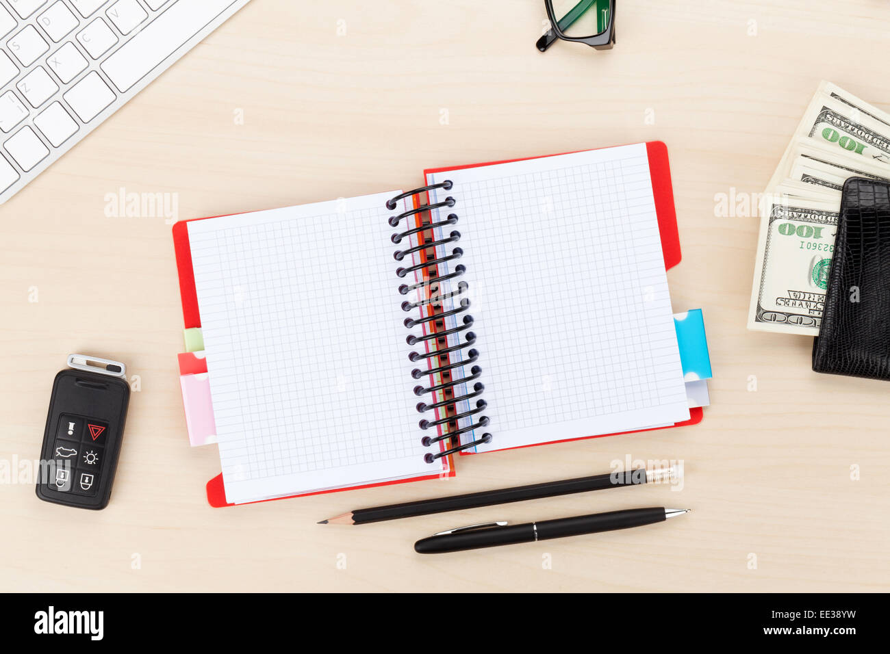 Office table with pc, supplies and money cash. View from above with ...