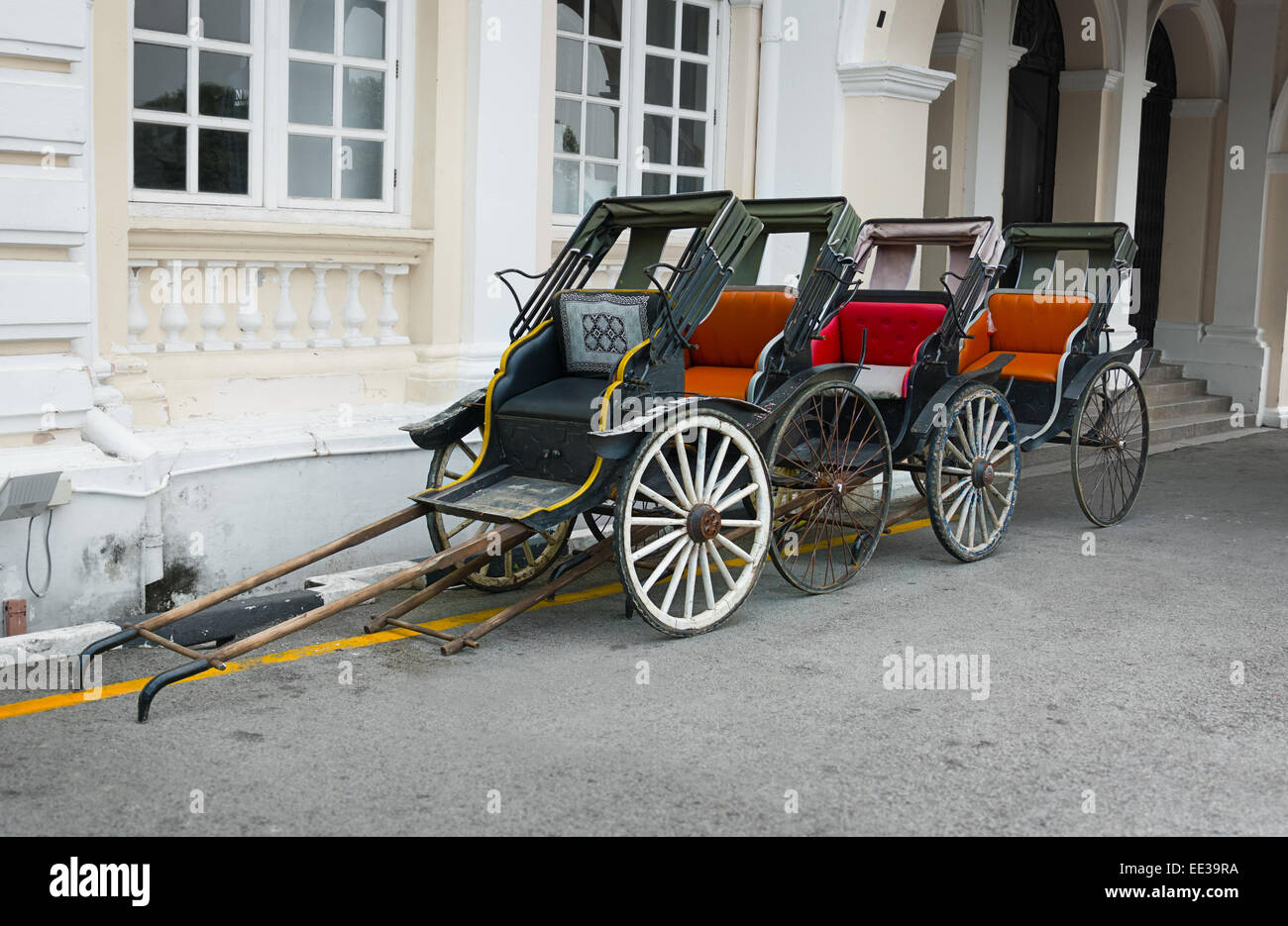 Four classic, old-fashined, manual rickshaws, lined up and waiting for ...