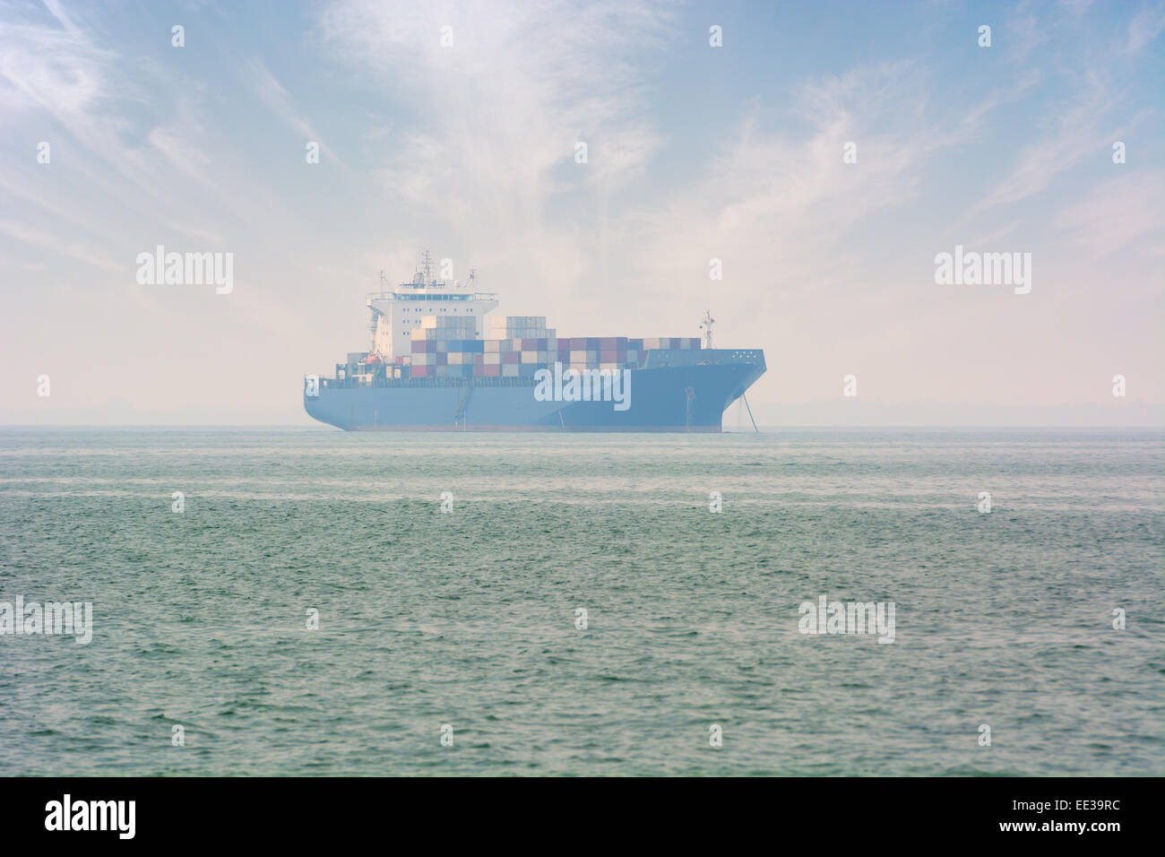 Large, fully-loaded, commercial container ship at anchor, just off the ...