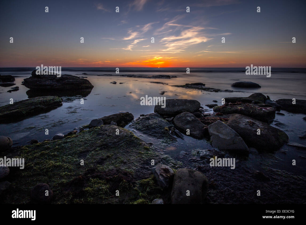 Rocky shore at sunset hi-res stock photography and images - Alamy