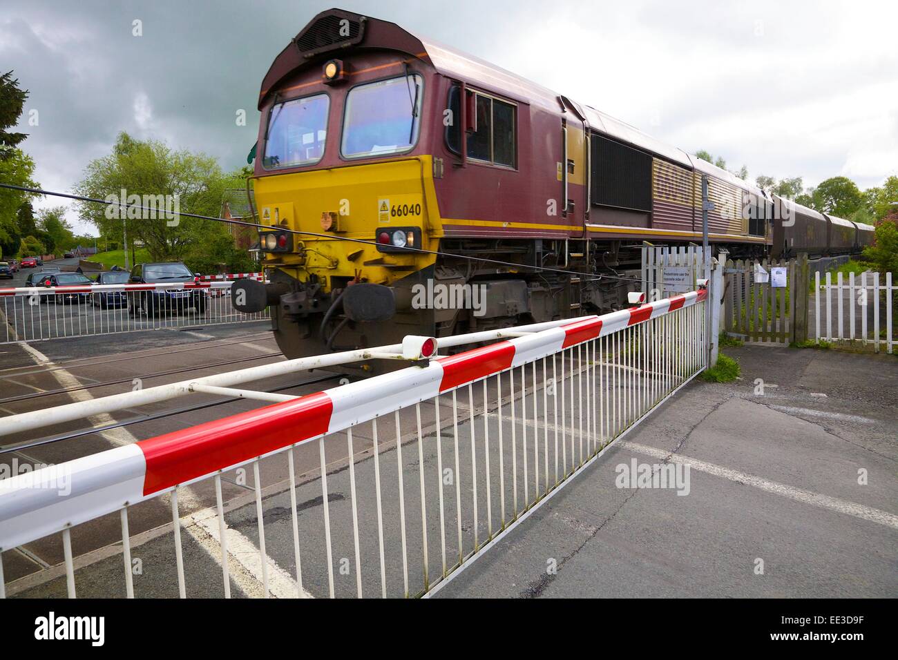 EWS train at level crossing Great Corby, Eden Valley, Cumbria, England ...