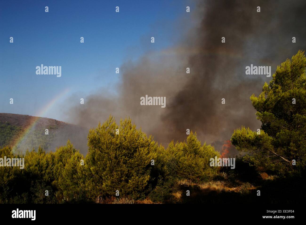 rainbow over bushfire Stock Photo - Alamy