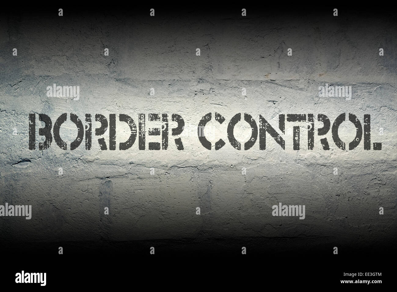 border control stencil print on the grunge white brick wall Stock Photo ...
