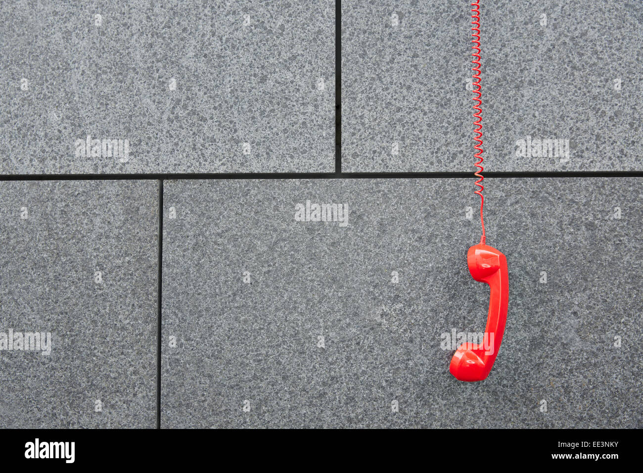 Red emercency call phone hanging down on a wall Stock Photo - Alamy