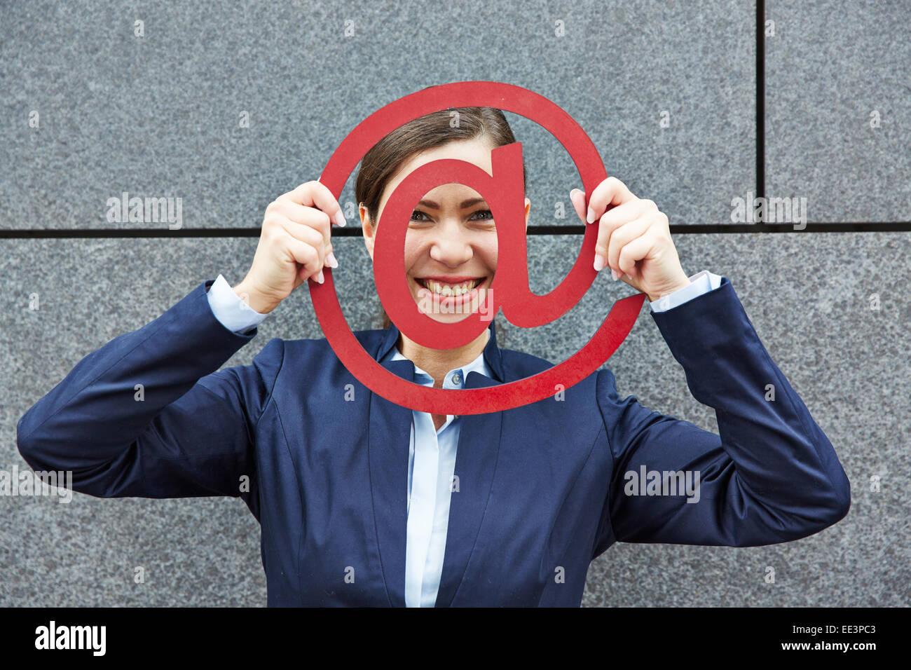 Happy business woman looking through at sign as email and internet ...