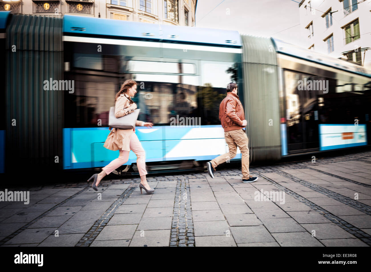 Young couple running after cable car, Munich, Bavaria, Germany Stock ...