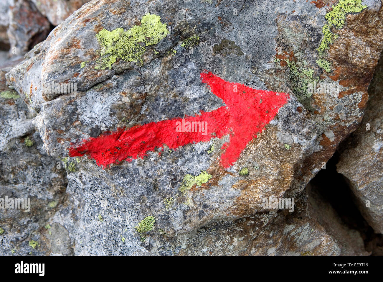 Red arrow on stone Stock Photo - Alamy