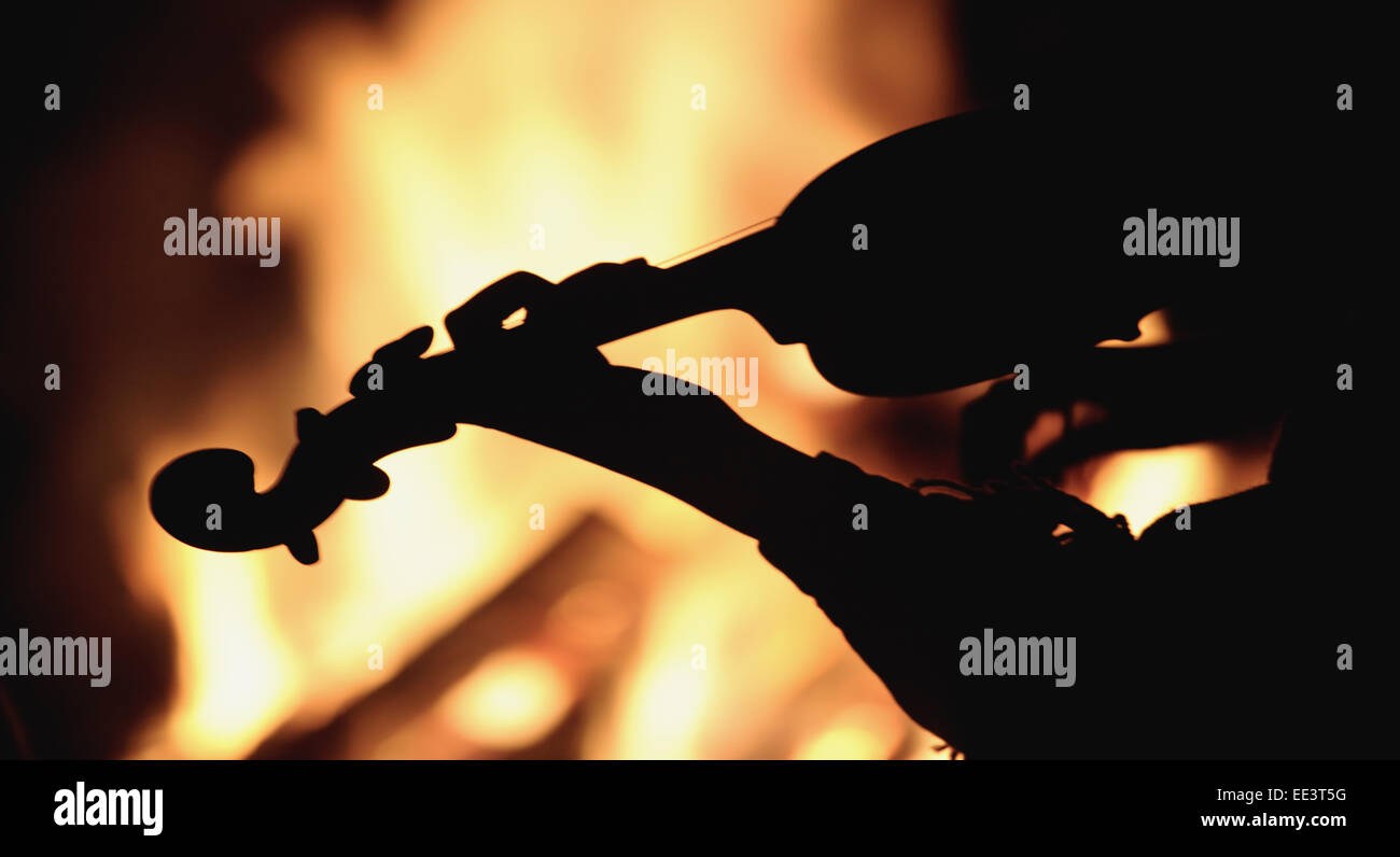 Musician playing violin. Backgroun fire Stock Photo - Alamy