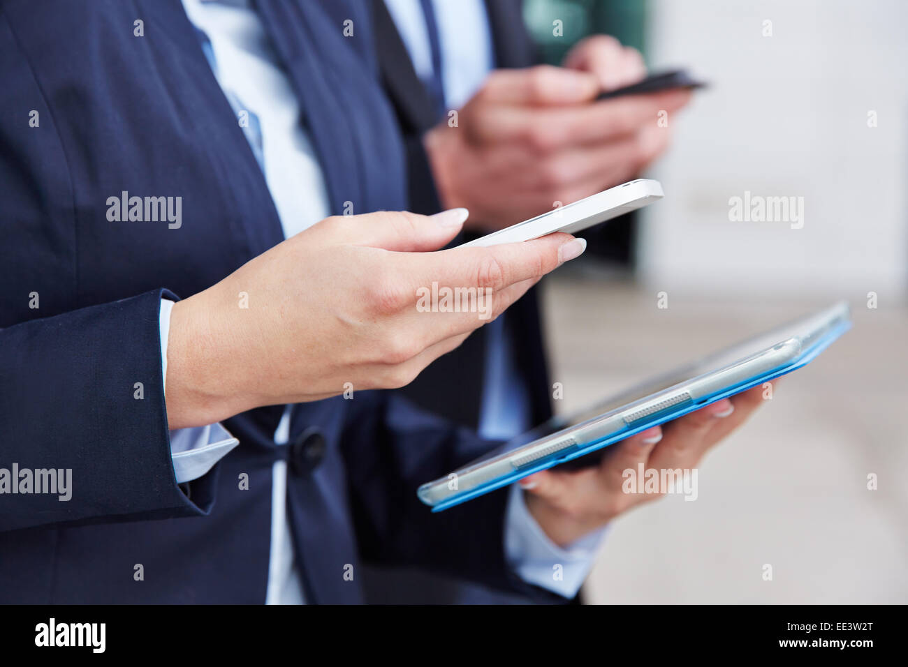 Hands of two business people with tablet computer and smartphones Stock ...