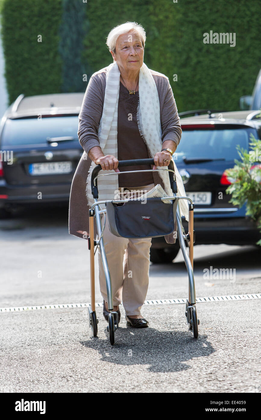 Seniors, elderly woman in her mid 70's, walking with a walker Stock ...