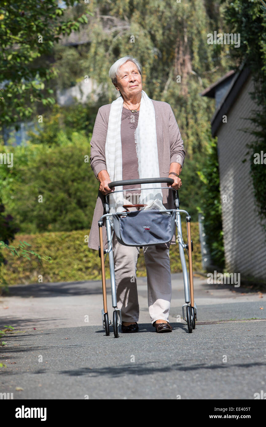 Seniors, elderly woman in her mid 70's, walking with a walker Stock ...