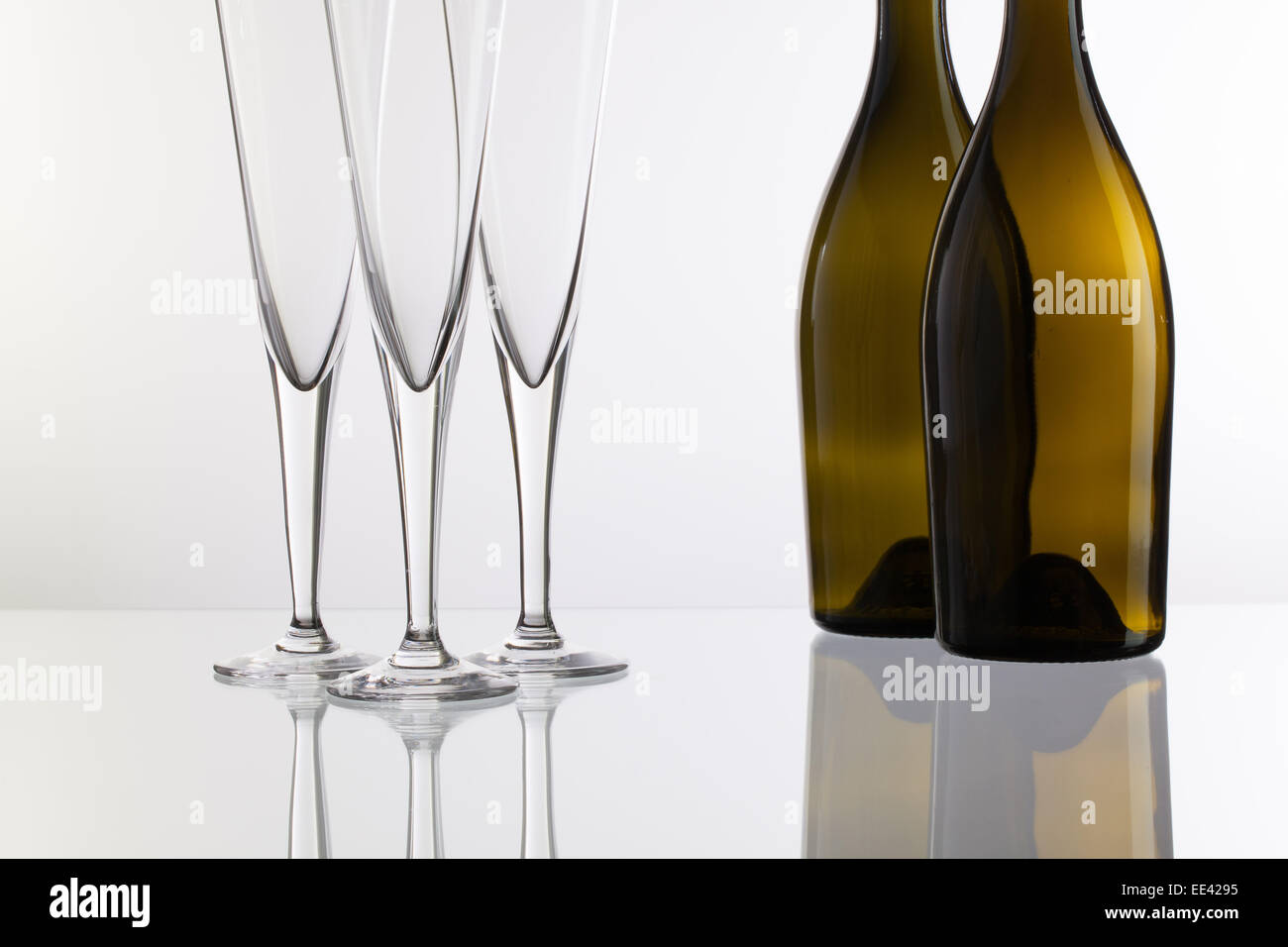 Empty champagne glasses on the glass desk Stock Photo - Alamy