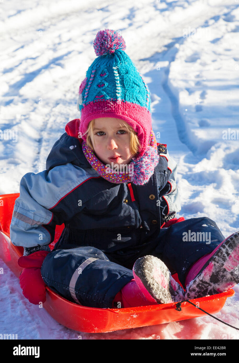 Young girl sledging Stock Photo - Alamy