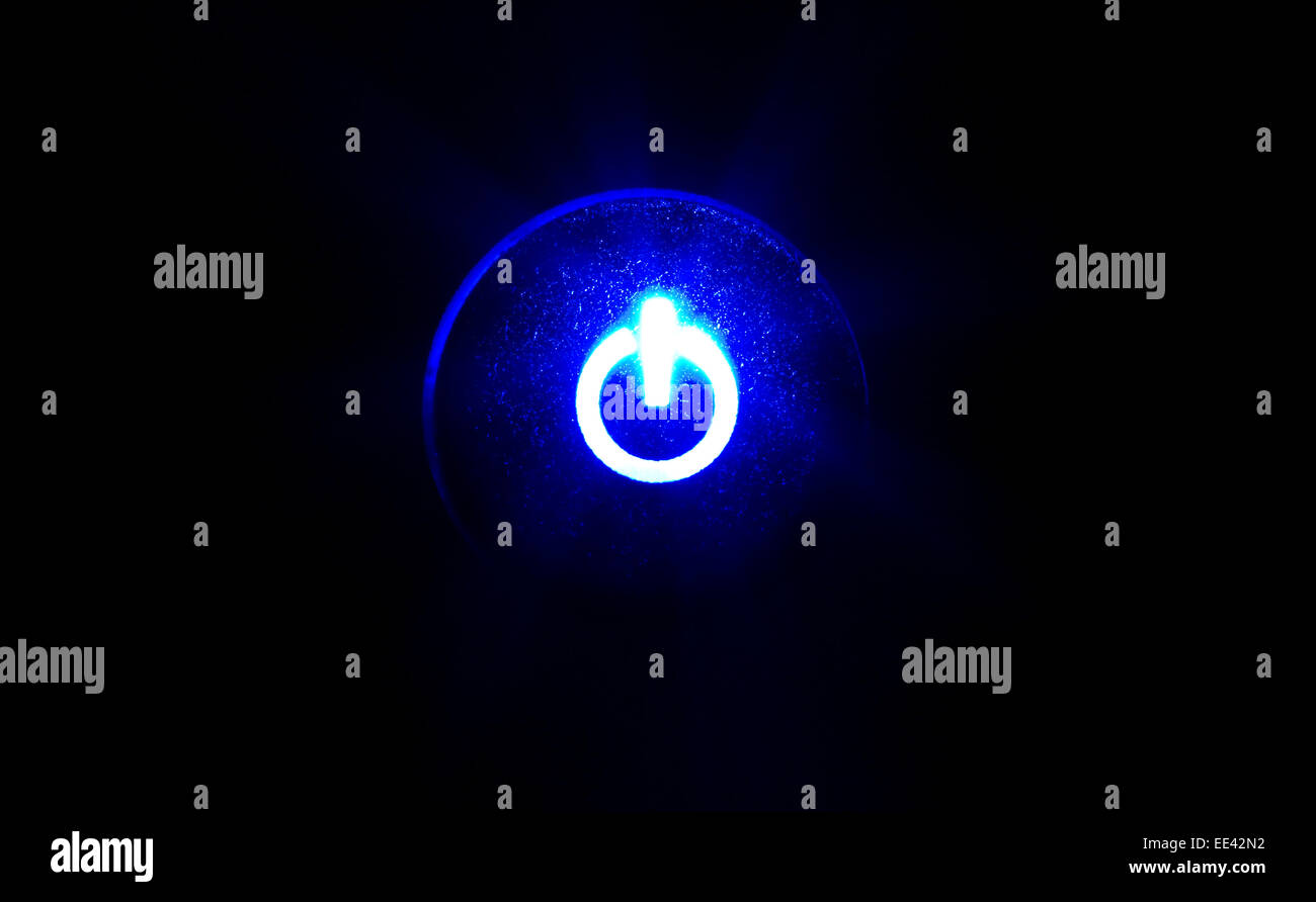 Blue glowing power button on a black pattern background Stock Photo - Alamy