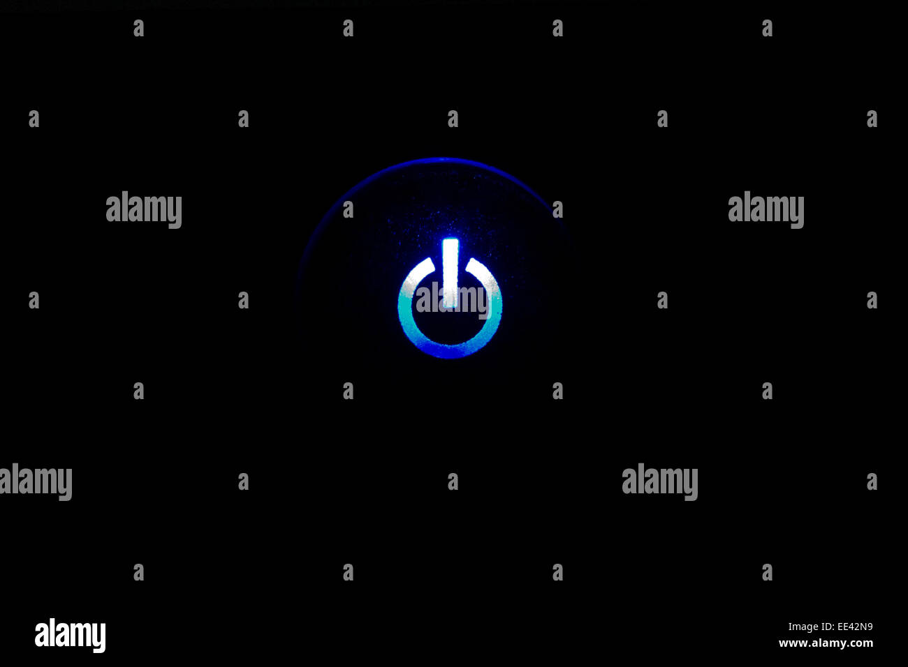 Blue glowing power button on a black pattern background Stock Photo - Alamy
