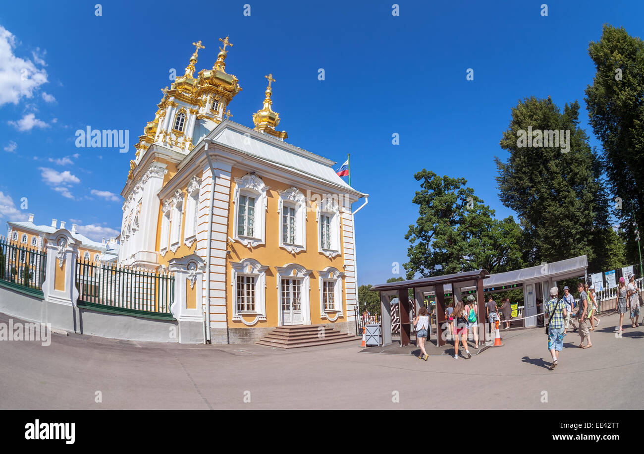 People walking in front a Chapel of the main buildings at Peterhof ...
