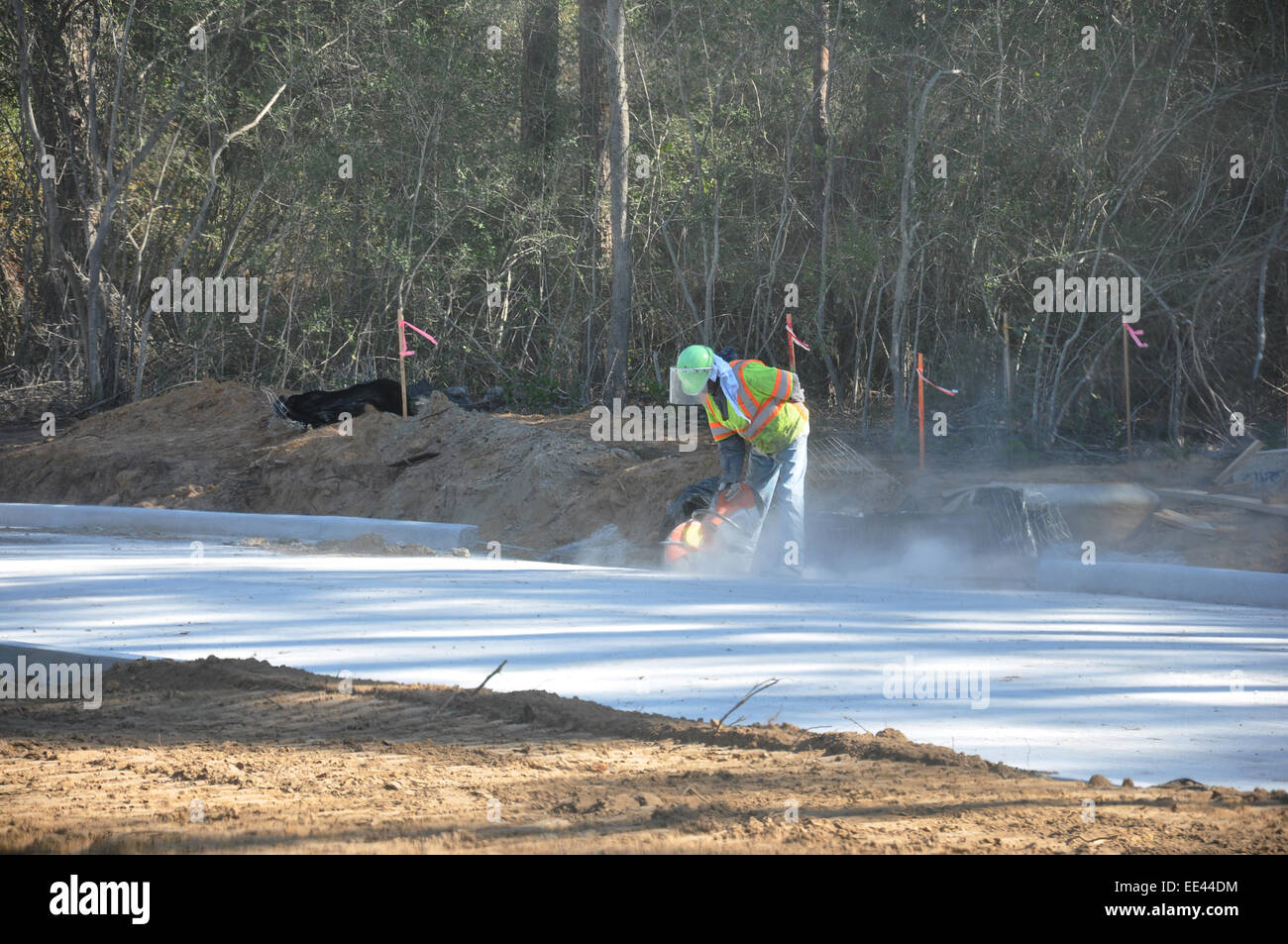 a single construction worker cutting a new road Stock Photo - Alamy