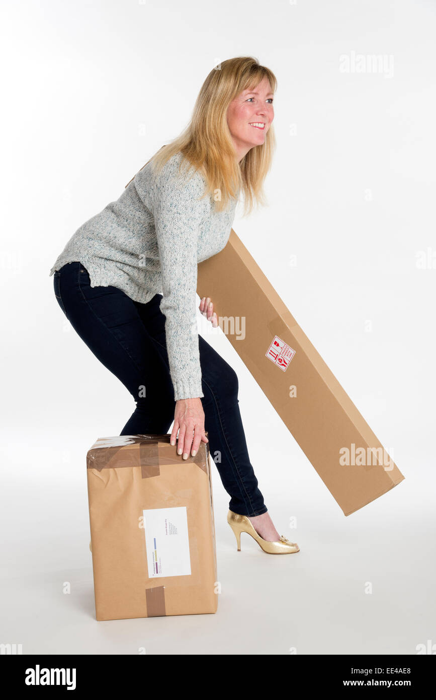 Woman carrying cardboard boxes Stock Photo - Alamy