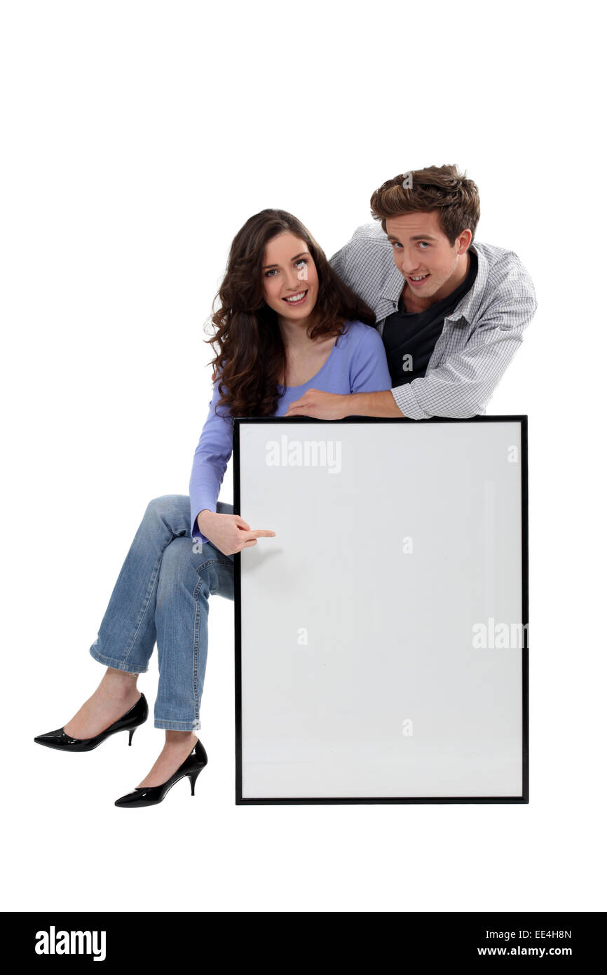 Young couple with a large picture left blank for your message Stock ...