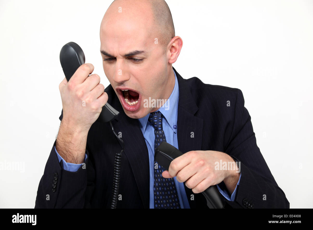 man shouting angrily in receiver Stock Photo - Alamy