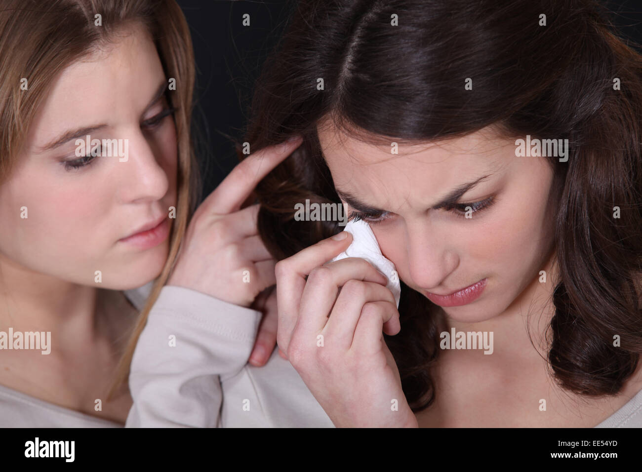 Young woman consoling a friend Stock Photo - Alamy