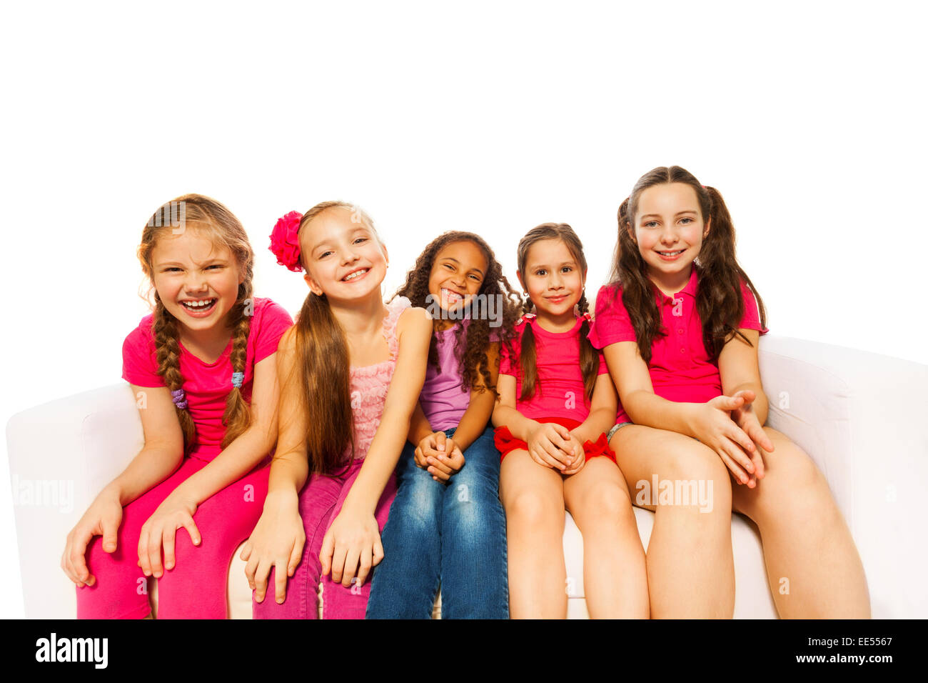 Smiling small girls sitting on white background Stock Photo - Alamy