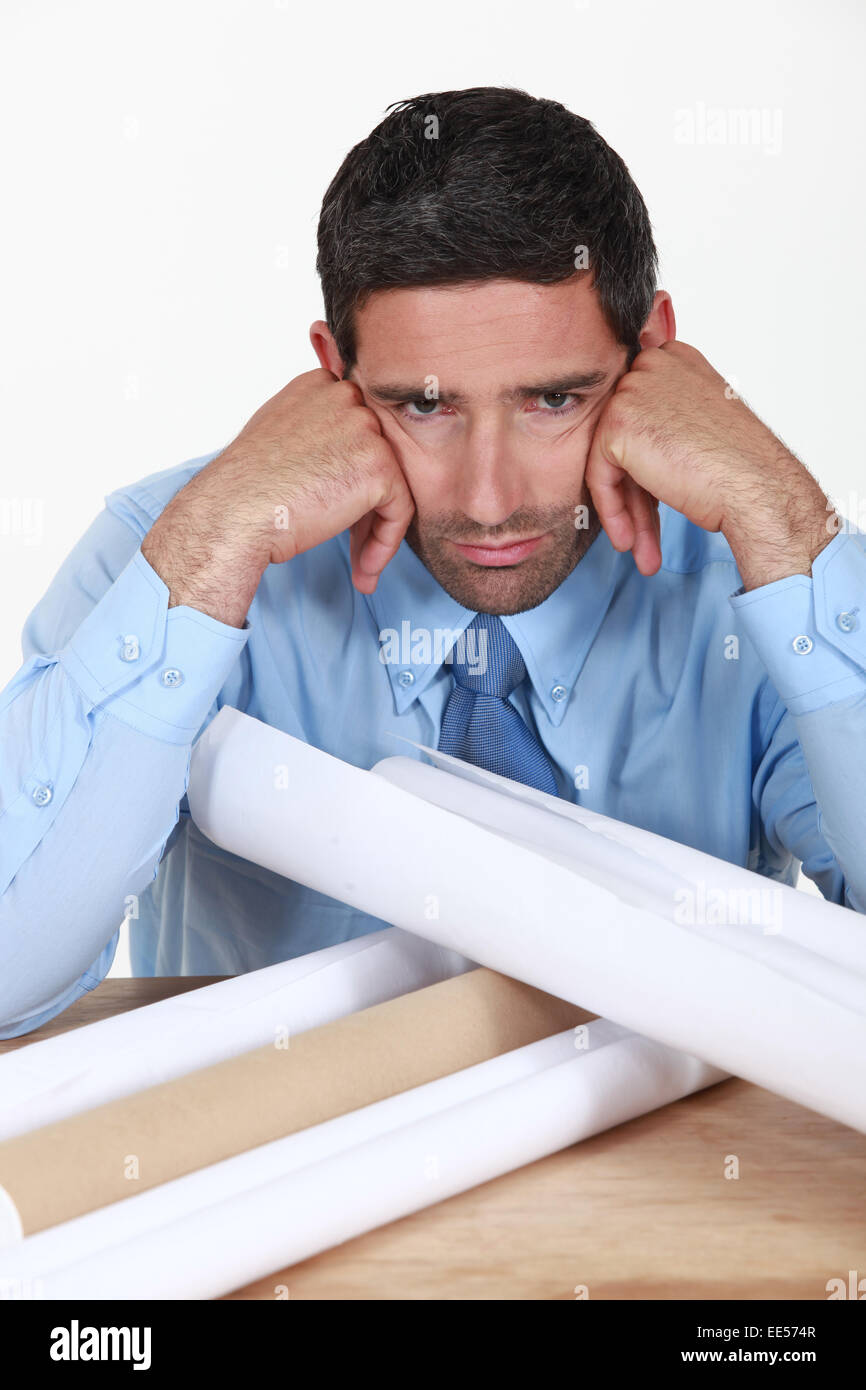 Male architect leaning over blueprints hi-res stock photography and ...