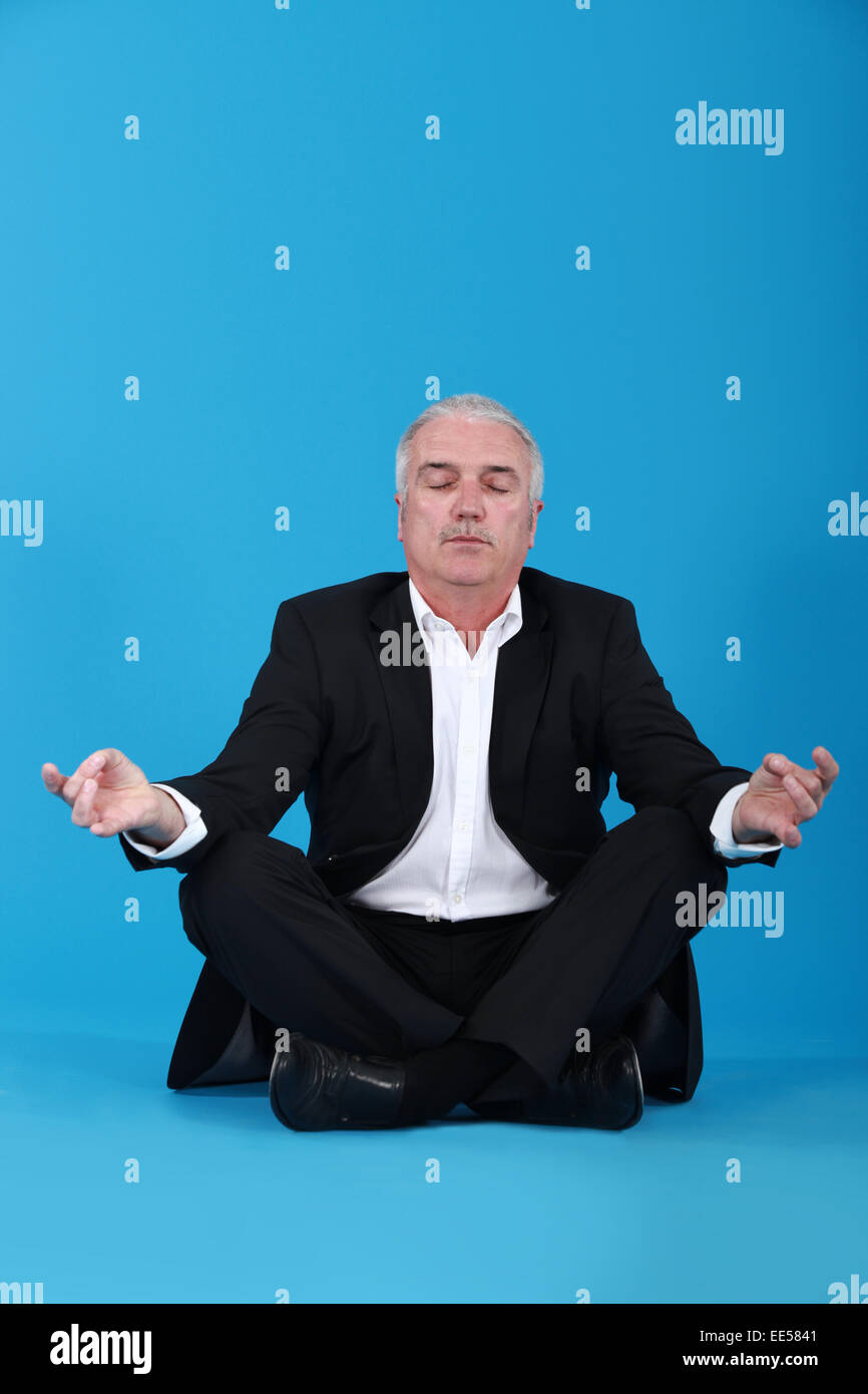 Businessman sitting in a lotus position Stock Photo - Alamy