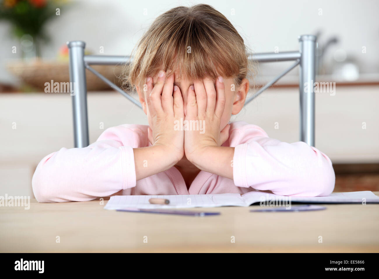 Frustrated child unable to complete her homework Stock Photo - Alamy