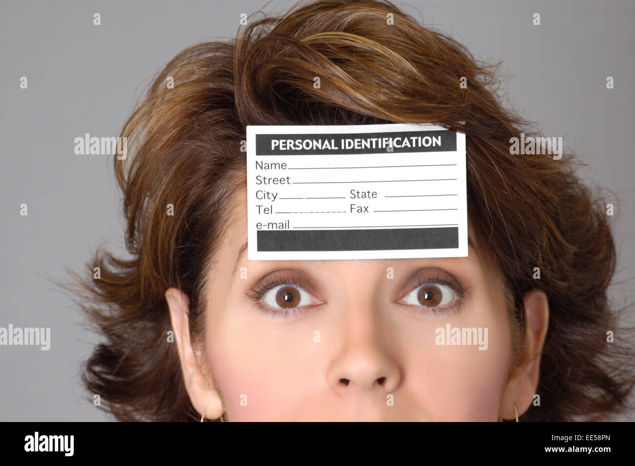 Woman wearing an identification card on her forehead. Can represent ...