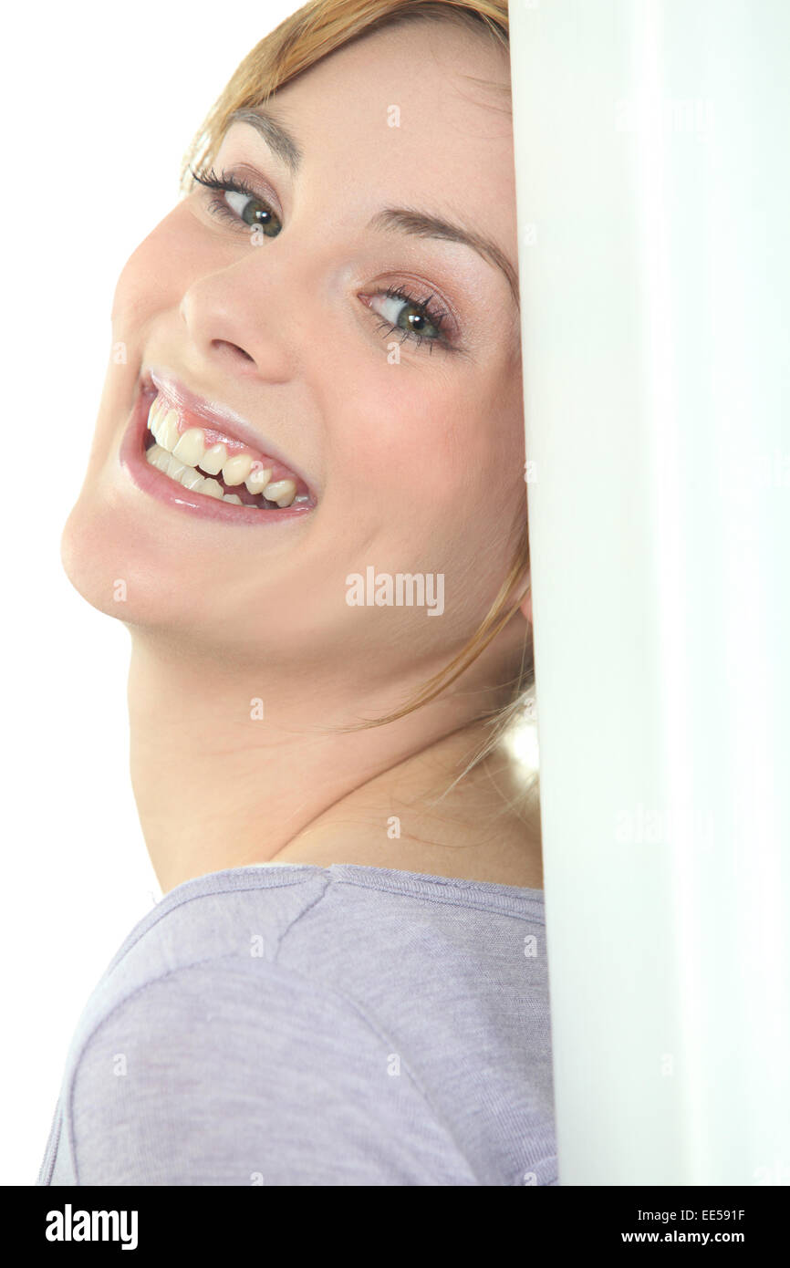 Pretty woman leaning against wall Stock Photo - Alamy