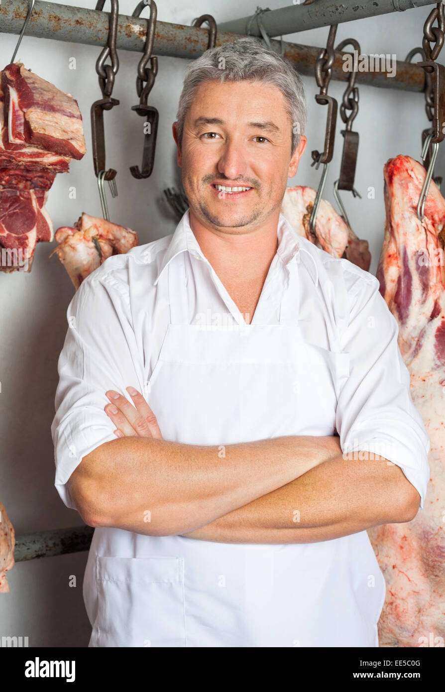 Confident Butcher Standing In Slaughterhouse Stock Photo - Alamy
