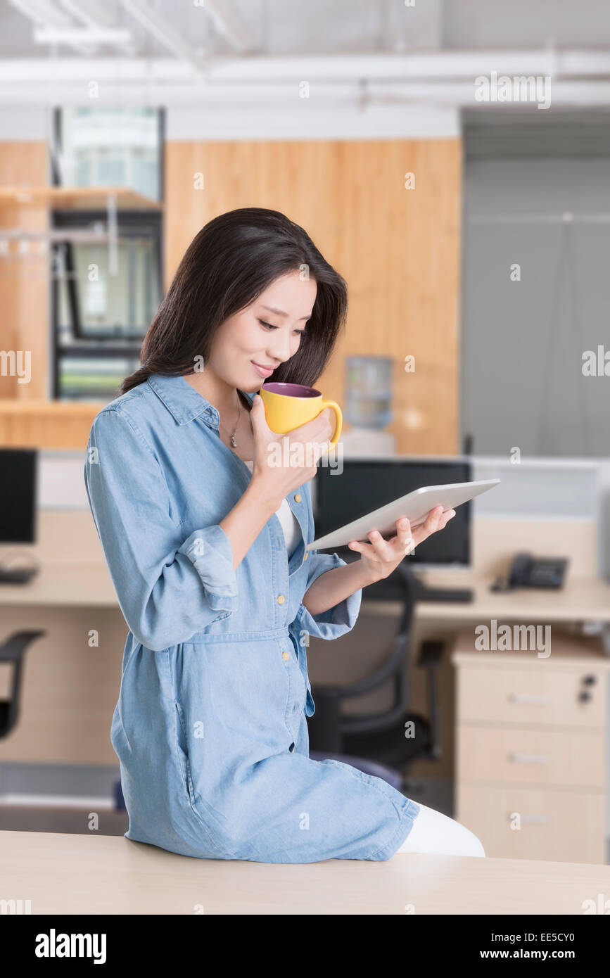 Creative worker using tablet in office space Stock Photo - Alamy