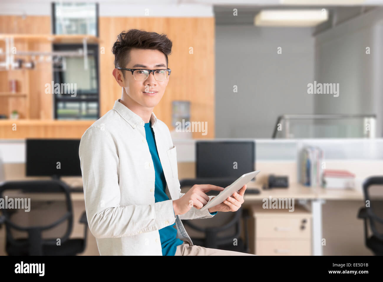 Creative worker using tablet in office space Stock Photo - Alamy