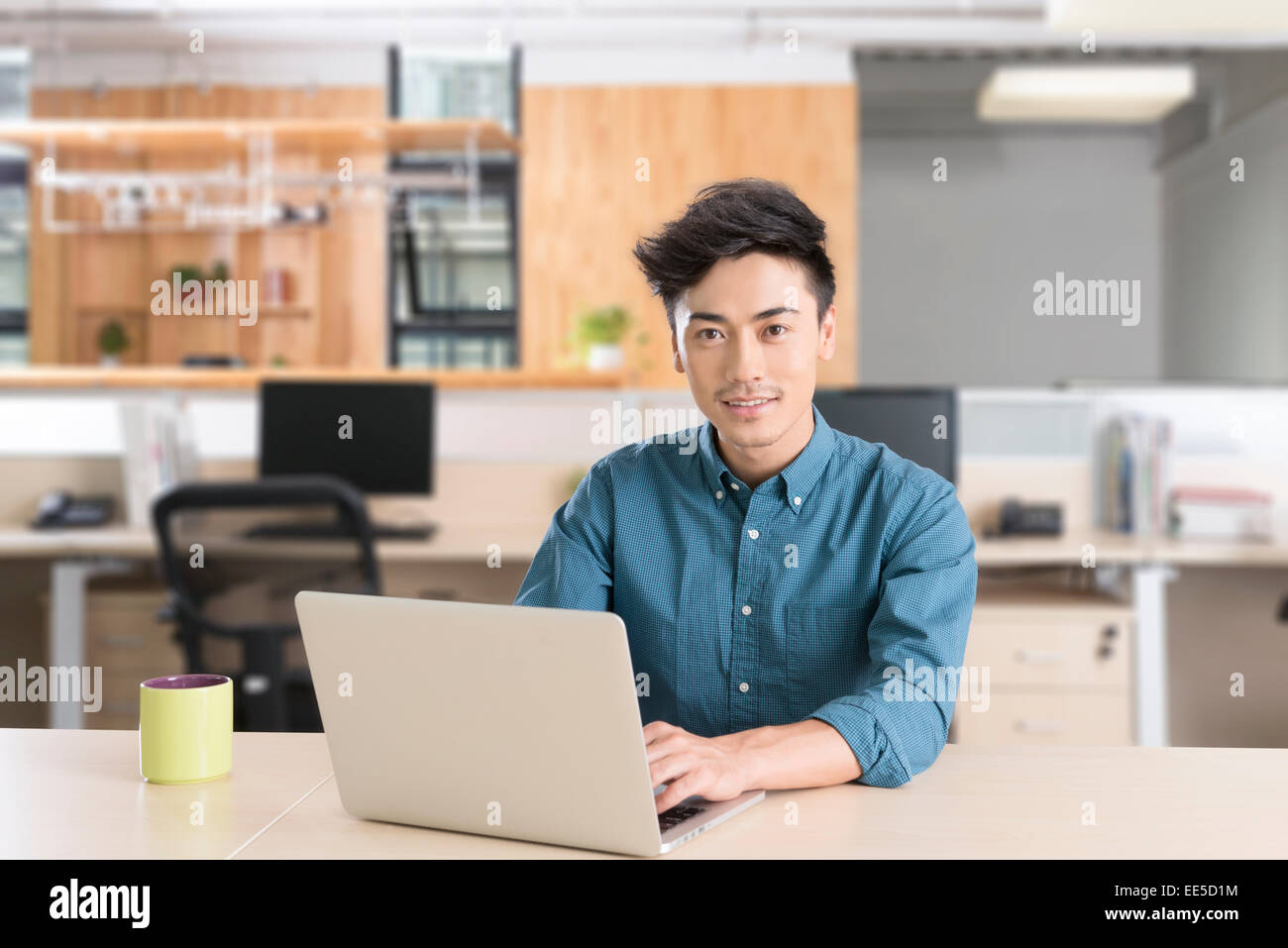 Creative worker using laptop in office space Stock Photo - Alamy
