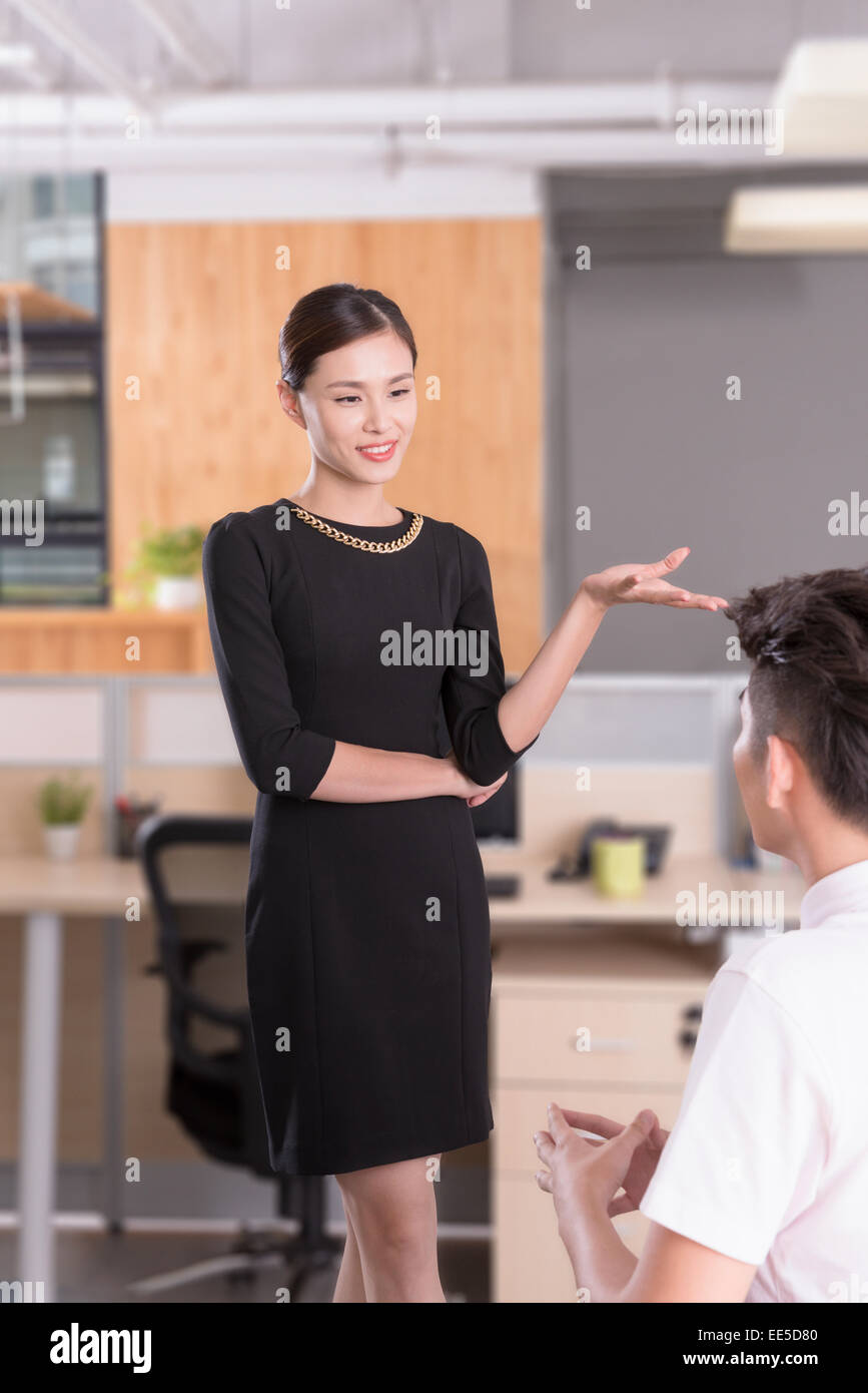 Creative workers talking in office space Stock Photo - Alamy