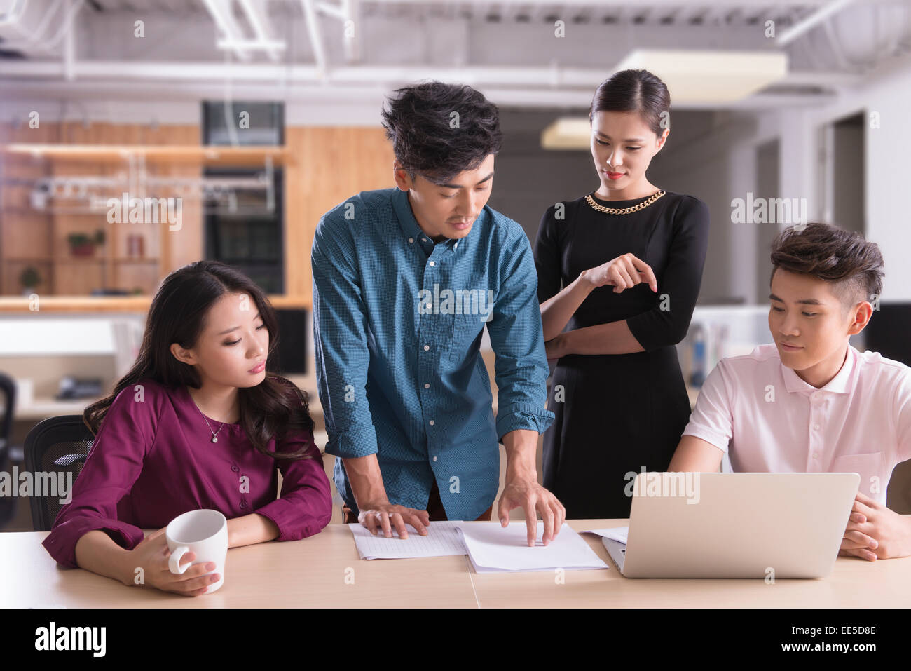 Creative workers having informal meeting in office space Stock Photo ...