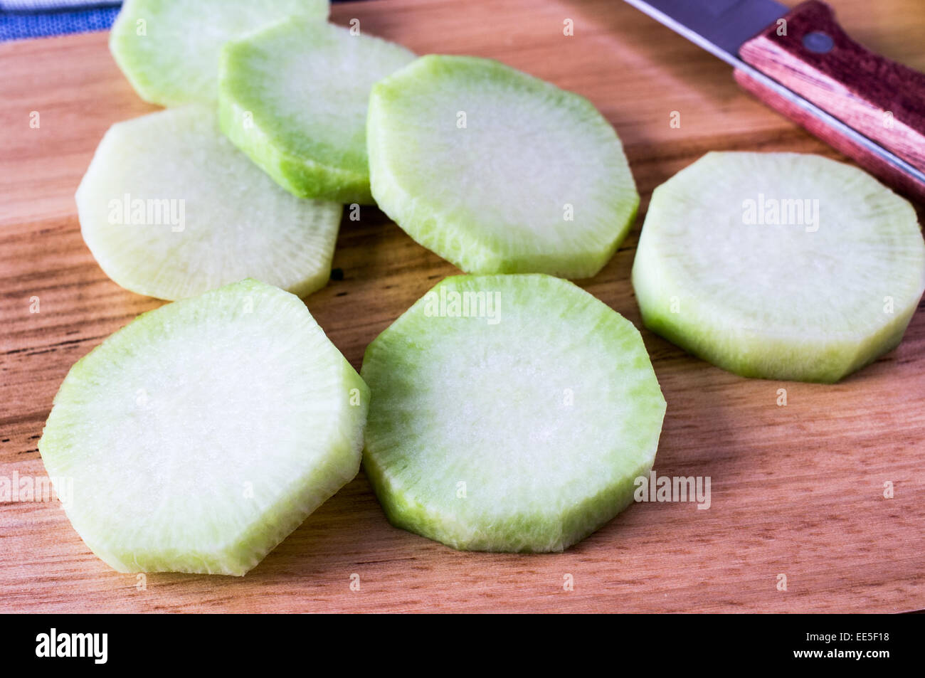 Radish slices cut with a knife on a cutting board Stock Photo - Alamy