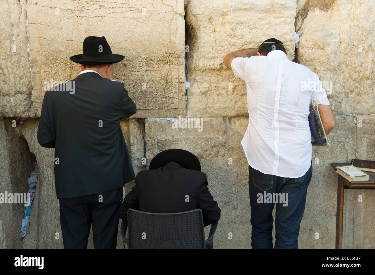 JERUSALEM, ISRAEL - OCT 06, 2014: Three jewish man are praying against ...