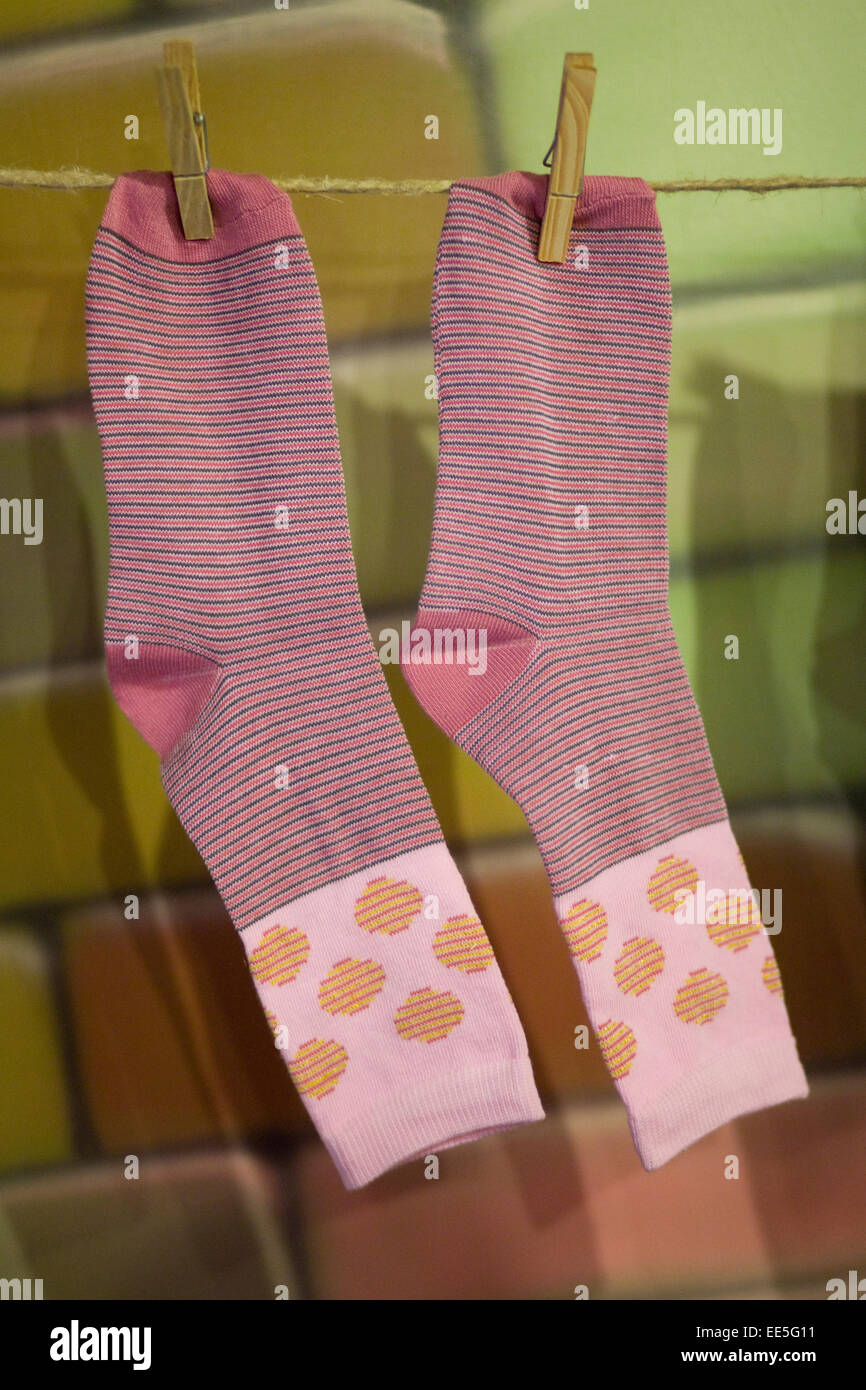 Socks hanging on an indoor washing line Stock Photo - Alamy