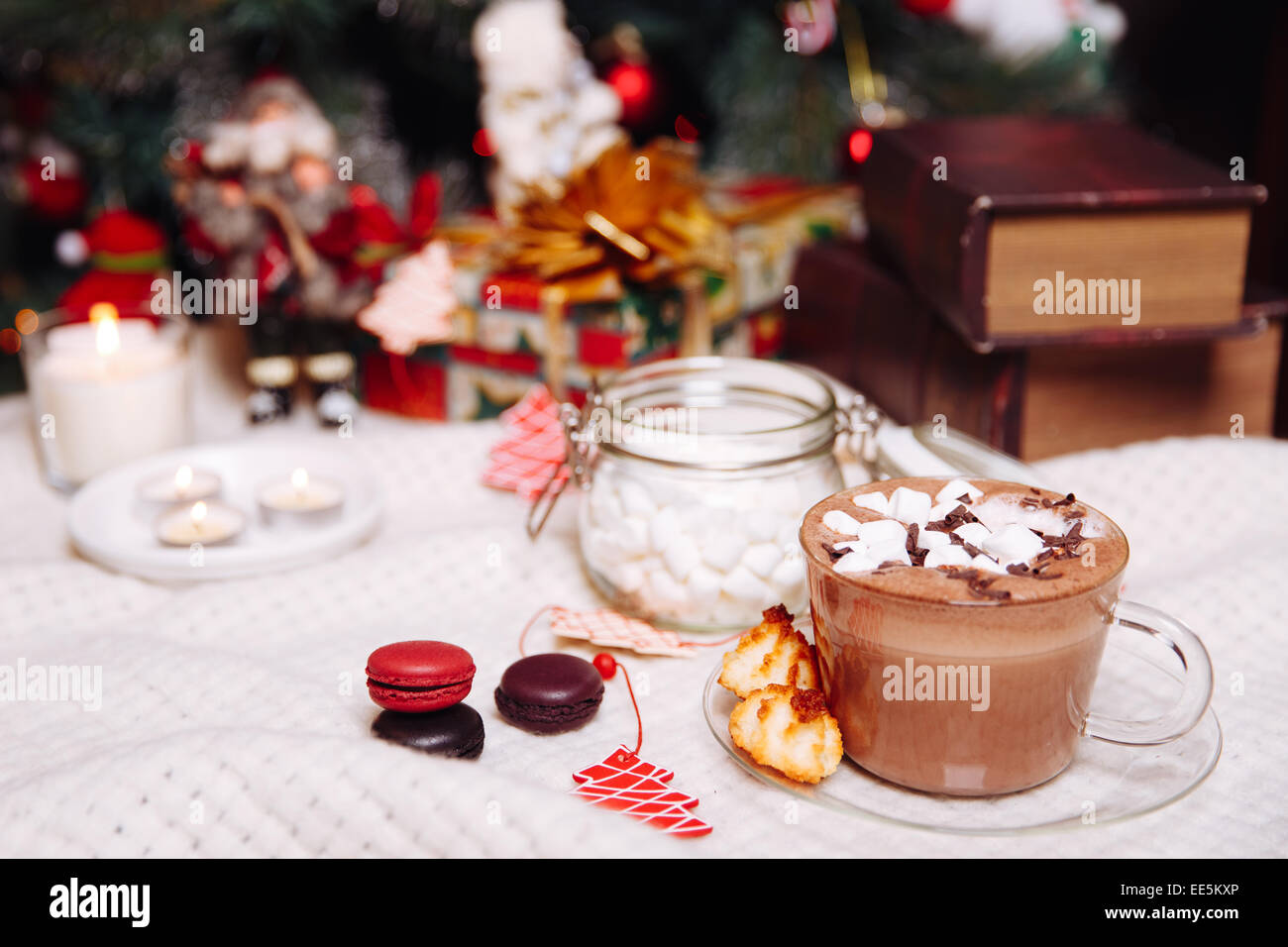 cup of cocoa with the foam in the festive decorations on white cloth ...