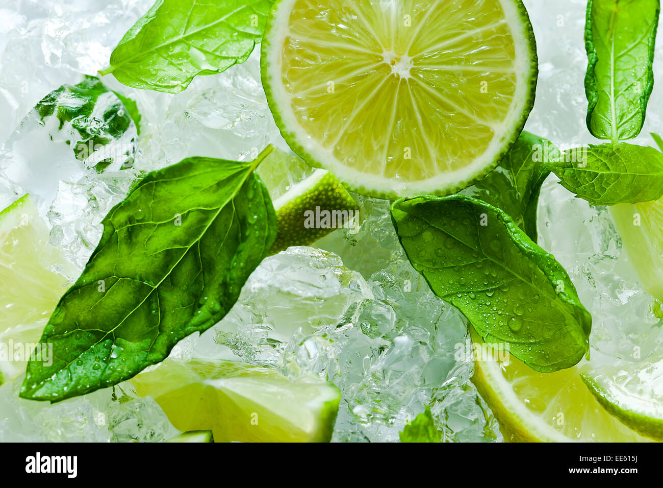 lime pieces and leaves of mint with ice Stock Photo - Alamy