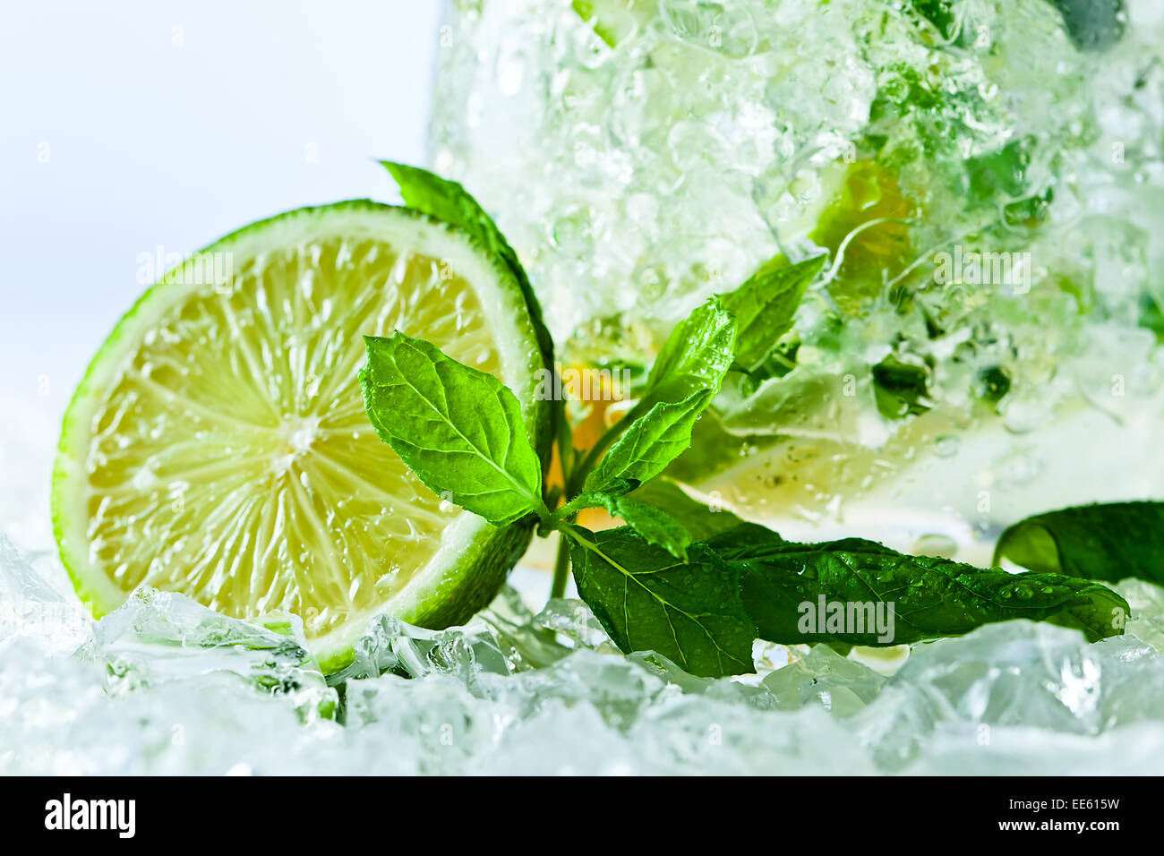 lime pieces and leaves of mint with ice Stock Photo - Alamy